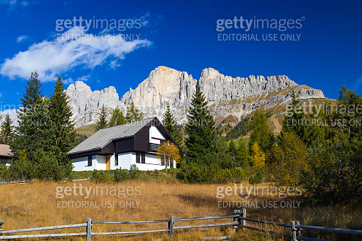 Alpine village of Carezza in the Dolomites with views of Mount Roda di ...