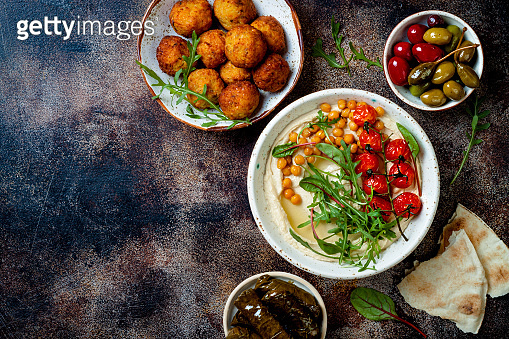 Homemade hummus with roasted cherry tomatoes and pita bread. Middle ...