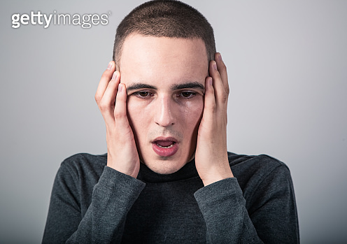 Unhappy crying man with dropping tears on the face with headache ...