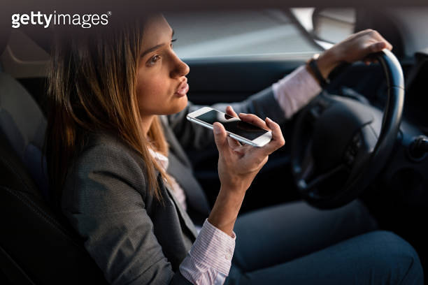 Businesswoman making a phone call while driving to work. (1185426243 ...
