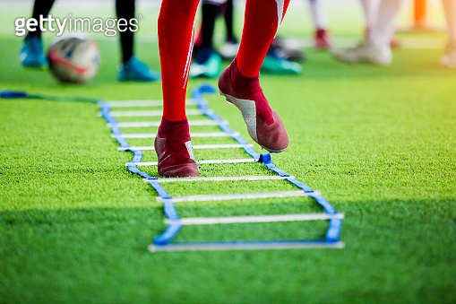 Young boy soccer players Jogging and jump between ladder drills for ...