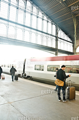 Tourists and travellers walking towards the platform to board a SNCF ...