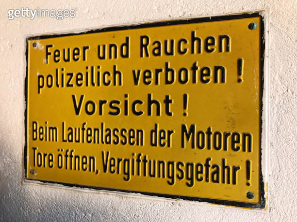 Warning sign: Beware, Fire and smoking is forbidden (in German language ...