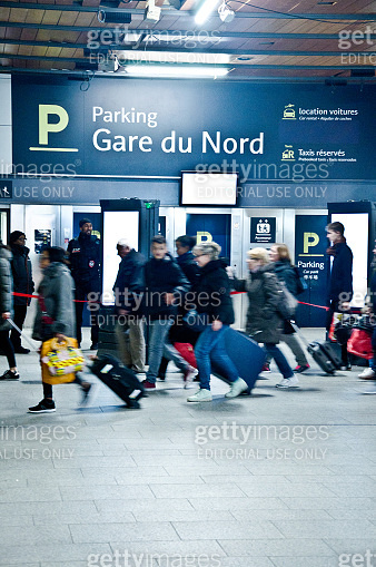Tourists and travellers walking towards the exit (or parking lot) at ...