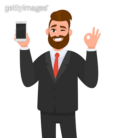 Happy successful businessman showing smart phone, mobile, cell phone in ...