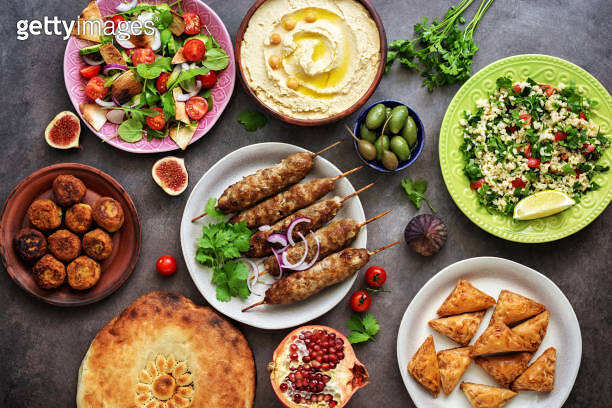 Assorted variety of Arabic and Middle Eastern food on a dark rustic ...