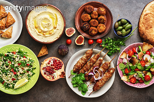 Arabic and Middle Eastern dinner table. Hummus, tabbouleh salad ...