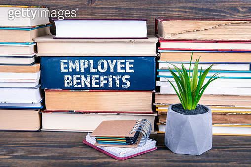 Employee Benefits concept. Books stacked on table 이미지 (1141673229) - 게티 ...