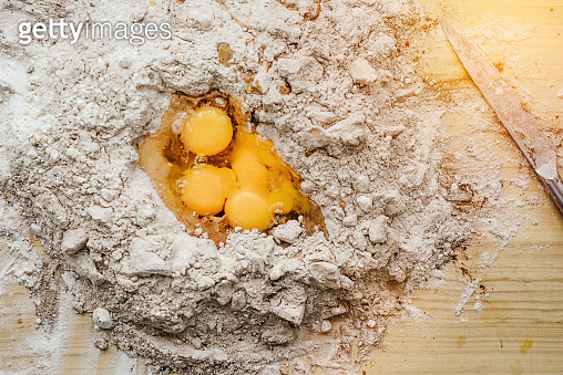 Broken egg in flour. Punching eggs for cake preparation. Concept of ...