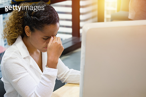 Adult American black woman sitting at the computer desk using her hands ...