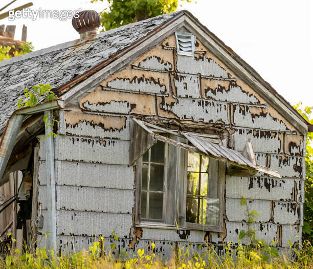 Ruins of old abandoned house, only the tattered facade remains ...