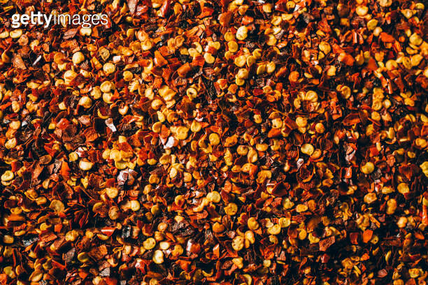 Close up view of chili flakes. Dried chili flakes as background. Close ...