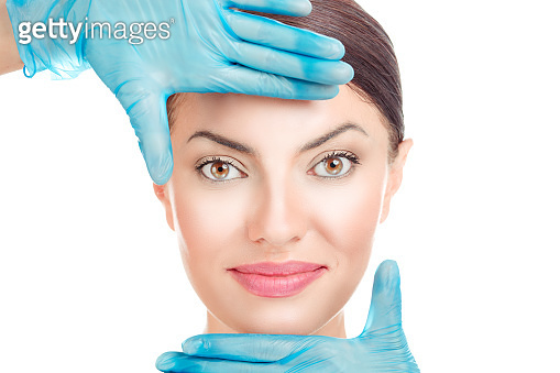 woman looking at camera, showing clean skin fresh face, with doctors ...
