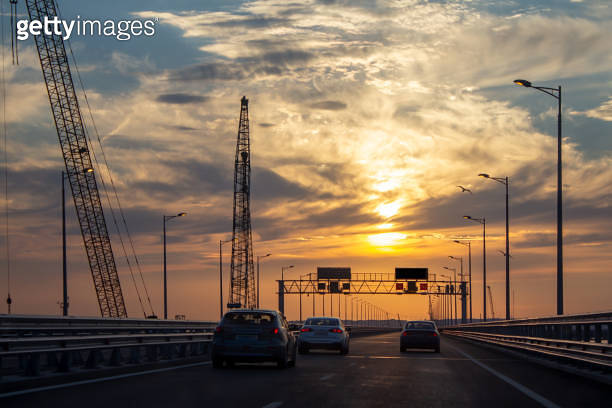 Riding a car over a bridge at sunset 이미지 (1169177700) - 게티이미지뱅크