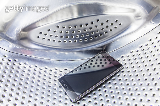fallen from the pocket of clothes cell phone is inside the washing ...
