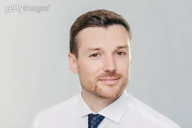 Portrait of confident unshaven businessman looks with self assured ...