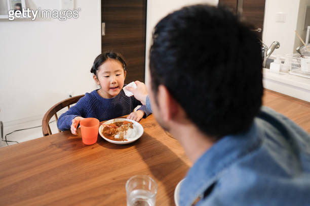 Father and daughter eating curry rice together at home (1130887379 ...