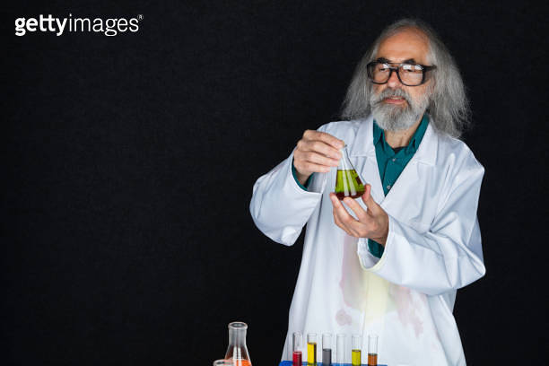 Scientist in a stained lab coat examining chemicals 이미지 (1143091978 ...