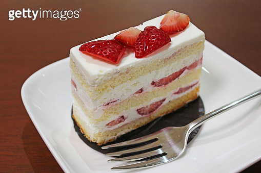 Rectangular strawberry fancy cake placed on a wooden table. 이미지 ...