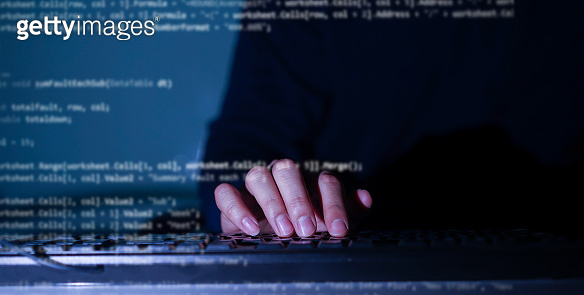 close up programmer man hand typing on keyboard at computer desktop for input coding language to ...