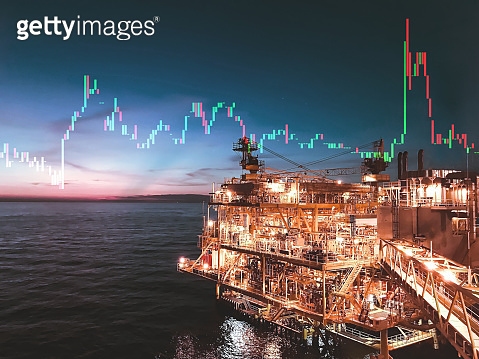 Double exposure of offshore platform with chart of stock trend for oil ...