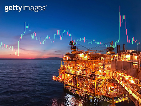 Double exposure of offshore platform with chart of stock trend for oil ...