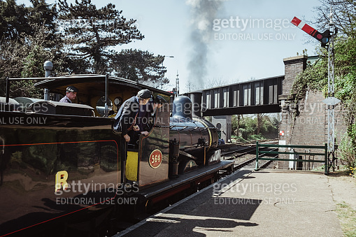 Crew looking out the cab on The Poppy Line steam train departing ...