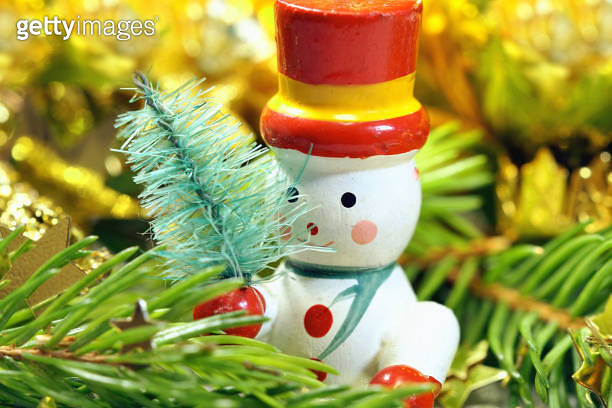 little snowman toy with red big hat on winter christmas background ...