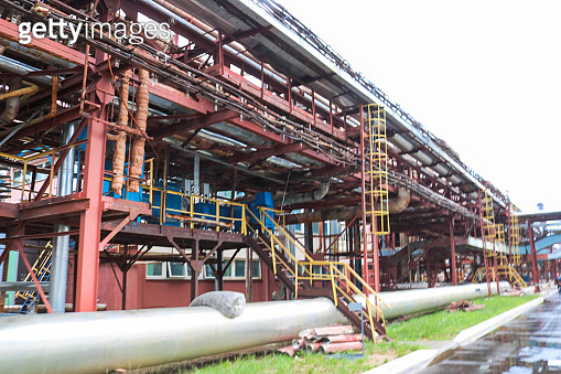 Large iron metal piping racks with pipe bends and passages, flange ...