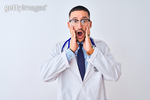 Young doctor man wearing stethoscope over isolated background afraid ...