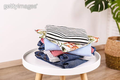 Bunch of different colorful clothing items folded in stack. 이미지 ...