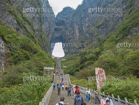 Crowd of tourist Climbing Heaven gate cave stairs on tianmen mountain ...