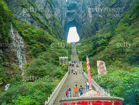 Crowd of tourist Climbing Heaven gate cave stairs on tianmen mountain ...