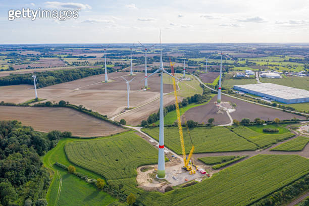 A large wind farm with many wind turbines is built near a small town in ...
