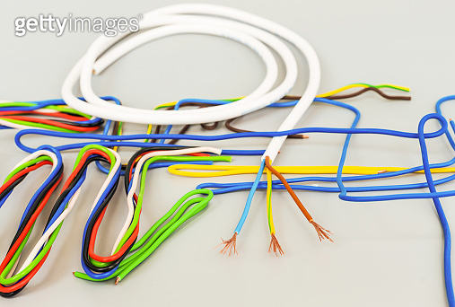 The wires of several types in colored insulation are curved in ...