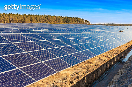 Sections of solar panels and a trench with a laid high-voltage cable ...