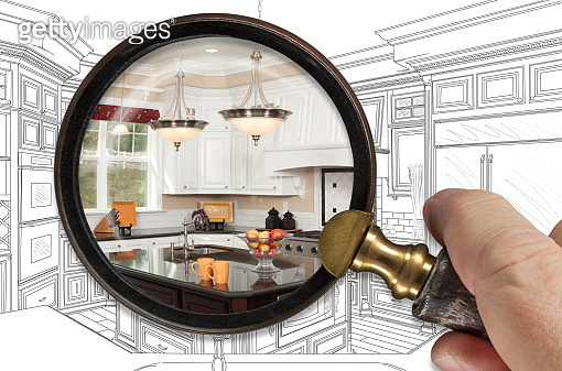 Hand Holding Magnifying Glass Revealing Finished Kitchen Build Over ...