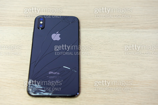 iPhone Ten X with broken display. Modern smartphone with damaged glass ...