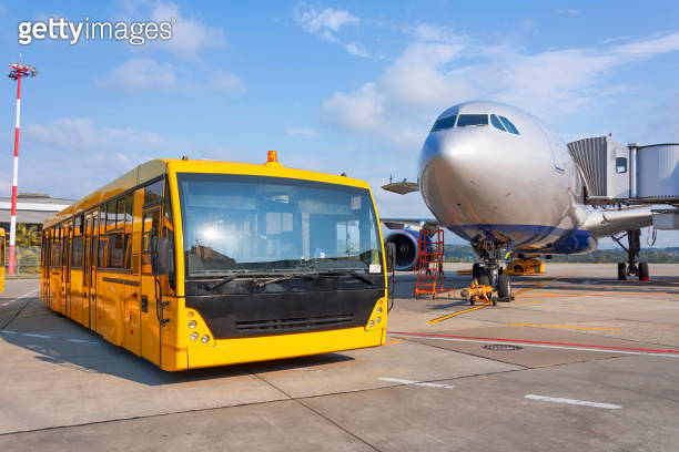 Shuttle yellow bus waiting for passengers on the plane for ...