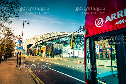 Traditional London bus and Exterior of new Tottenham Hotspur stadium in ...