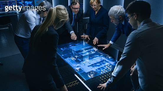 Team of Government Intelligence / FBI Agents Standing Around Digital ...