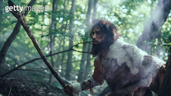 Portrait of Primeval Caveman Wearing Animal Skin and Fur Hunting with a ...