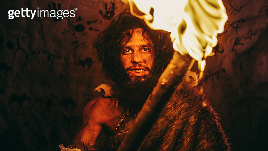 Portrait of Primeval Caveman Wearing Animal Skin Standing in His Cave ...