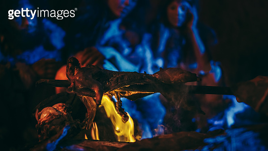 Neanderthal or Homo Sapiens Family Cooking Animal Meat over Bonfire and ...