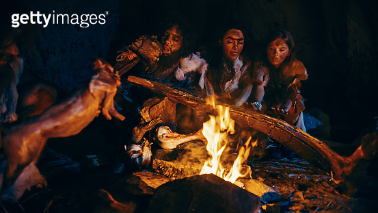 Neanderthal or Homo Sapiens Family Cooking Animal Meat over Bonfire and ...