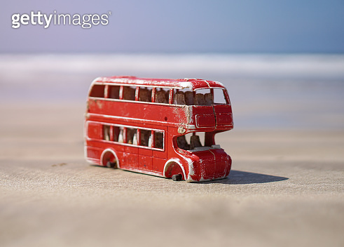 Red toy bus in nature pollutes the earth's ecosystem. English bus ...