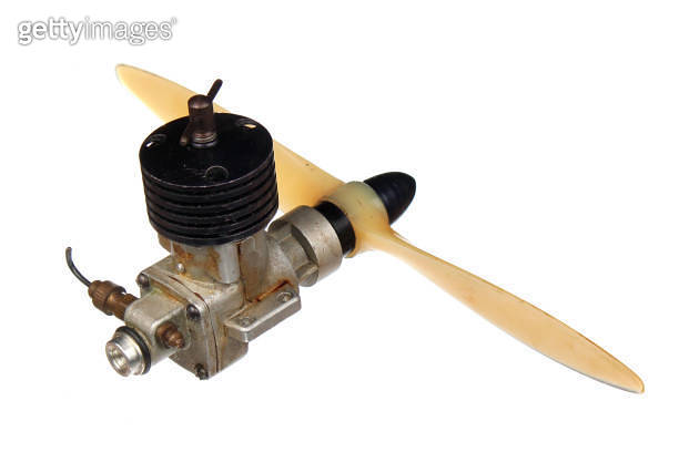 Small aircraft model diesel engine with propeller, isolated against ...