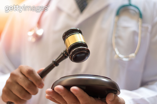 Forensic medicine concept. Pathologist doctor holding hammer court as ...