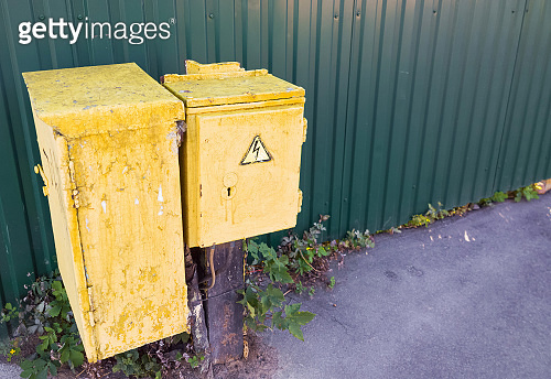 Old electric power box with warning voltage or electrical hazard sign ...