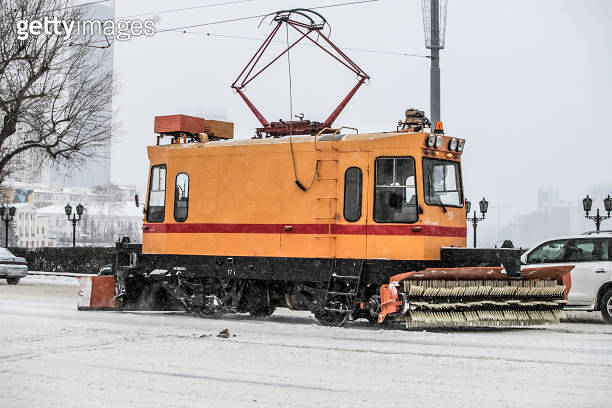 Tram snowplow with side wing blade removing snow and ice from Bucharest ...